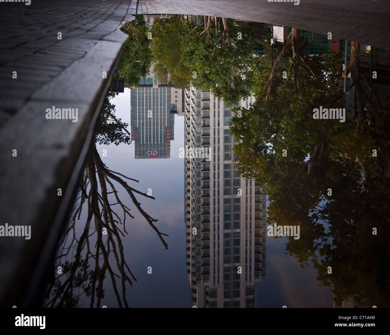 Buildings in London Docklands reflected in puddle Stock Photo - Alamy