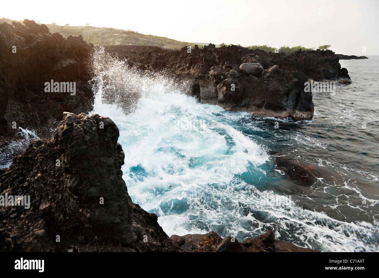 Waves crash over cliffs of lava rock Stock Photo - Alamy