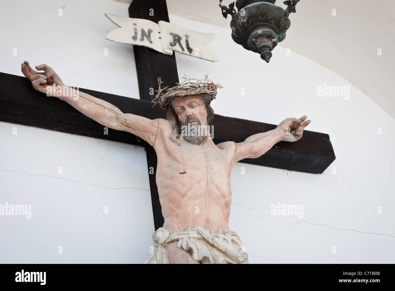 Fragment of typical crucifix symbol of christianity. Wooden statue ...