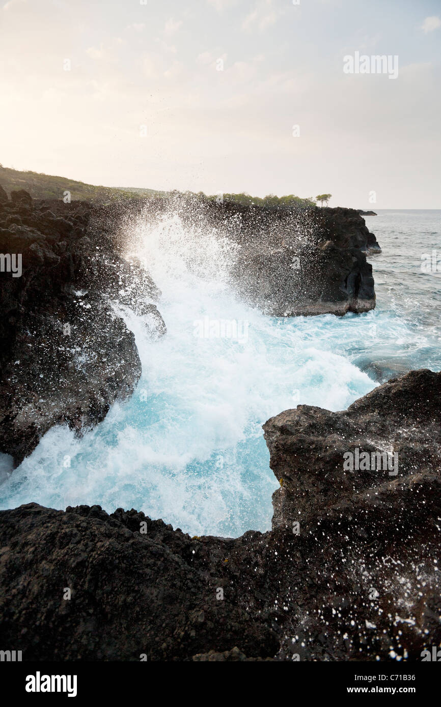 Waves crash over cliffs of lava rock Stock Photo - Alamy