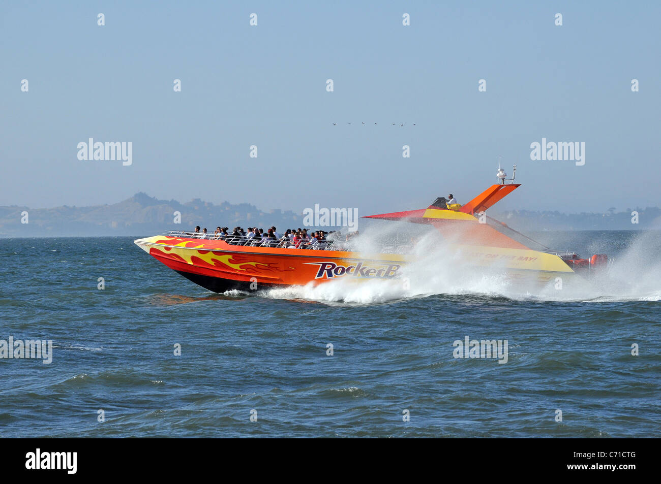The water-jet boat "Bay Rocket" carrying tourists on a high speed trip ...