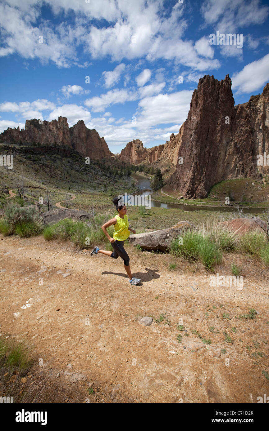 Female trail running with river in distance Stock Photo - Alamy