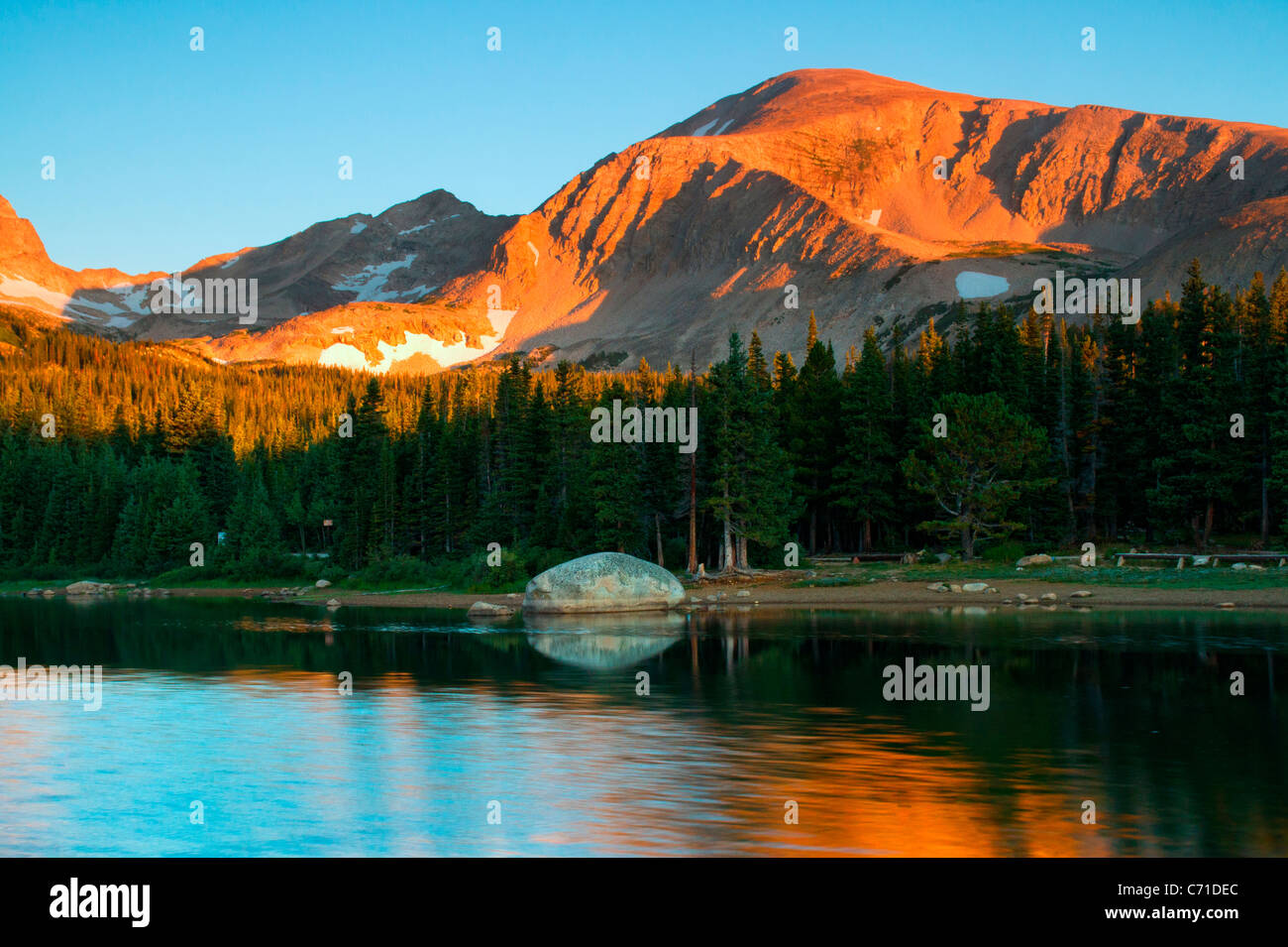 The rising sun hits the peaks of the Colorado Rocky Mountains at Lake ...