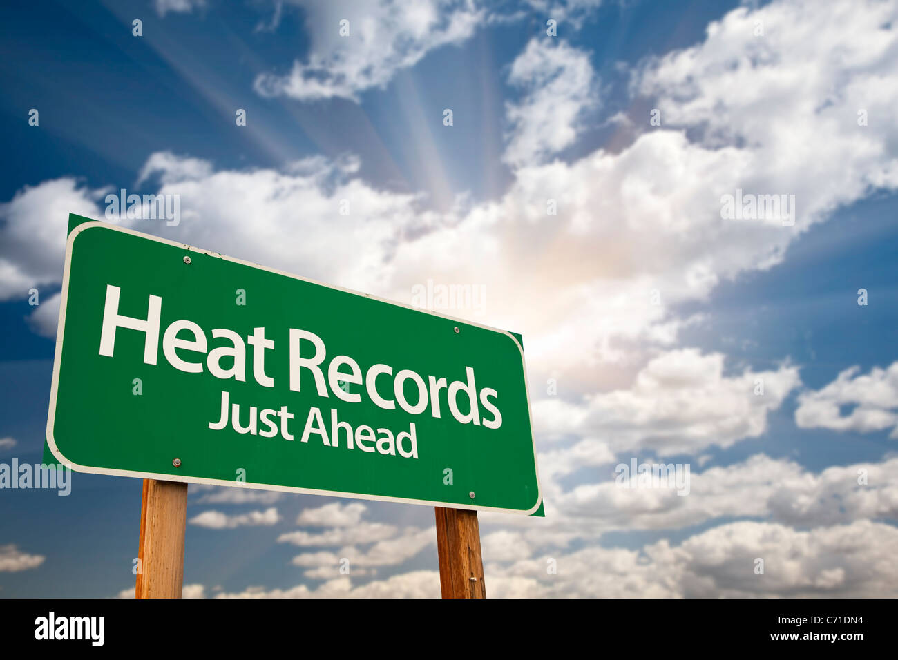 Heat Records Green Road Sign Against Dramatic Sky, Clouds and Sunburst ...