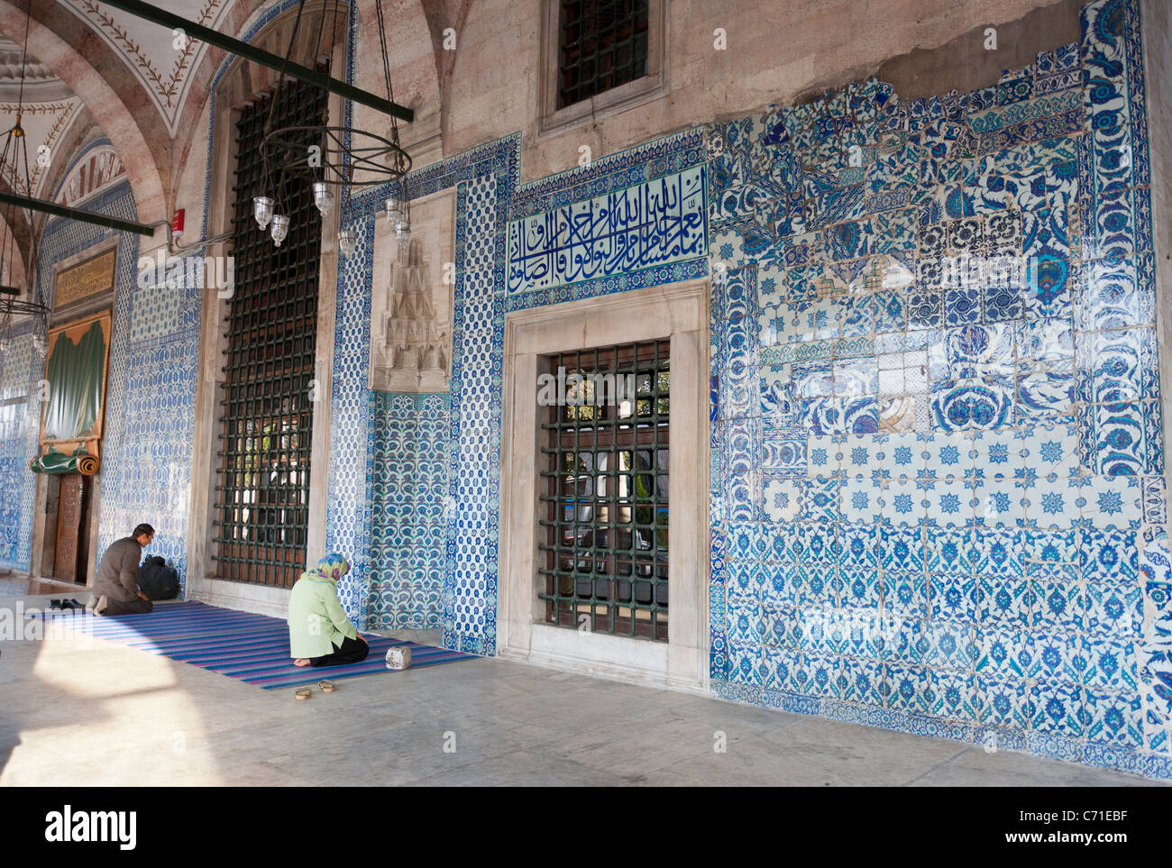 Outsiders Praying. A man and woman pray in the outside courtyard of the ...