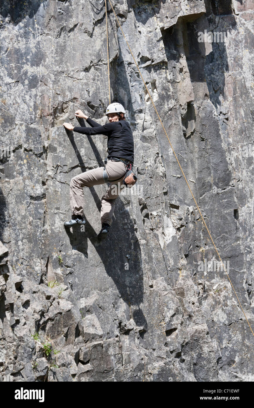 Shear face: Rope Climbing in the Cheddar Gorge. A climber clings to the ...