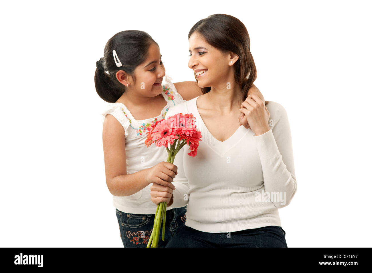 Girl giving her mother flowers Stock Photo - Alamy