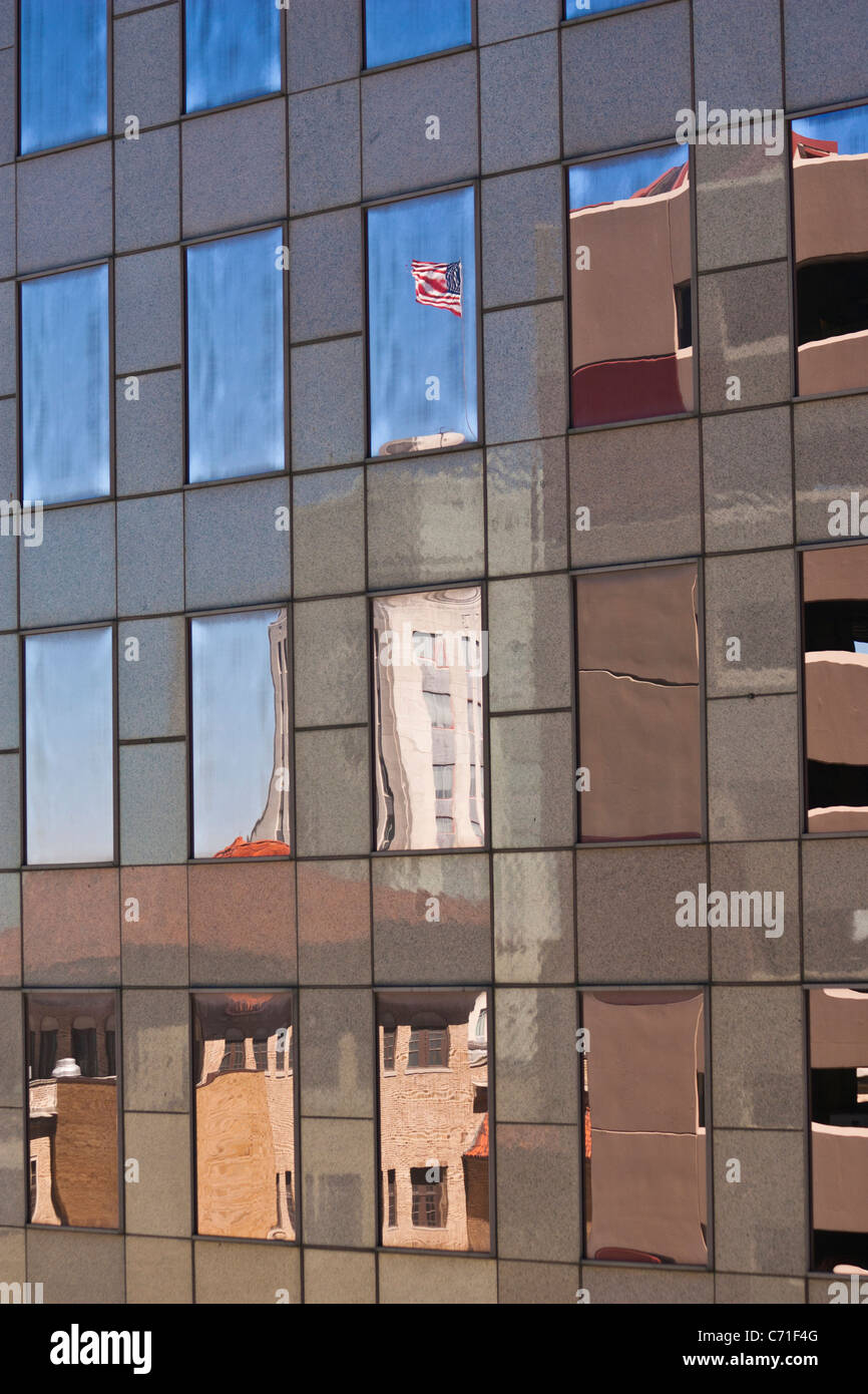 Mirror images and reflections in windows of building in downtown ...