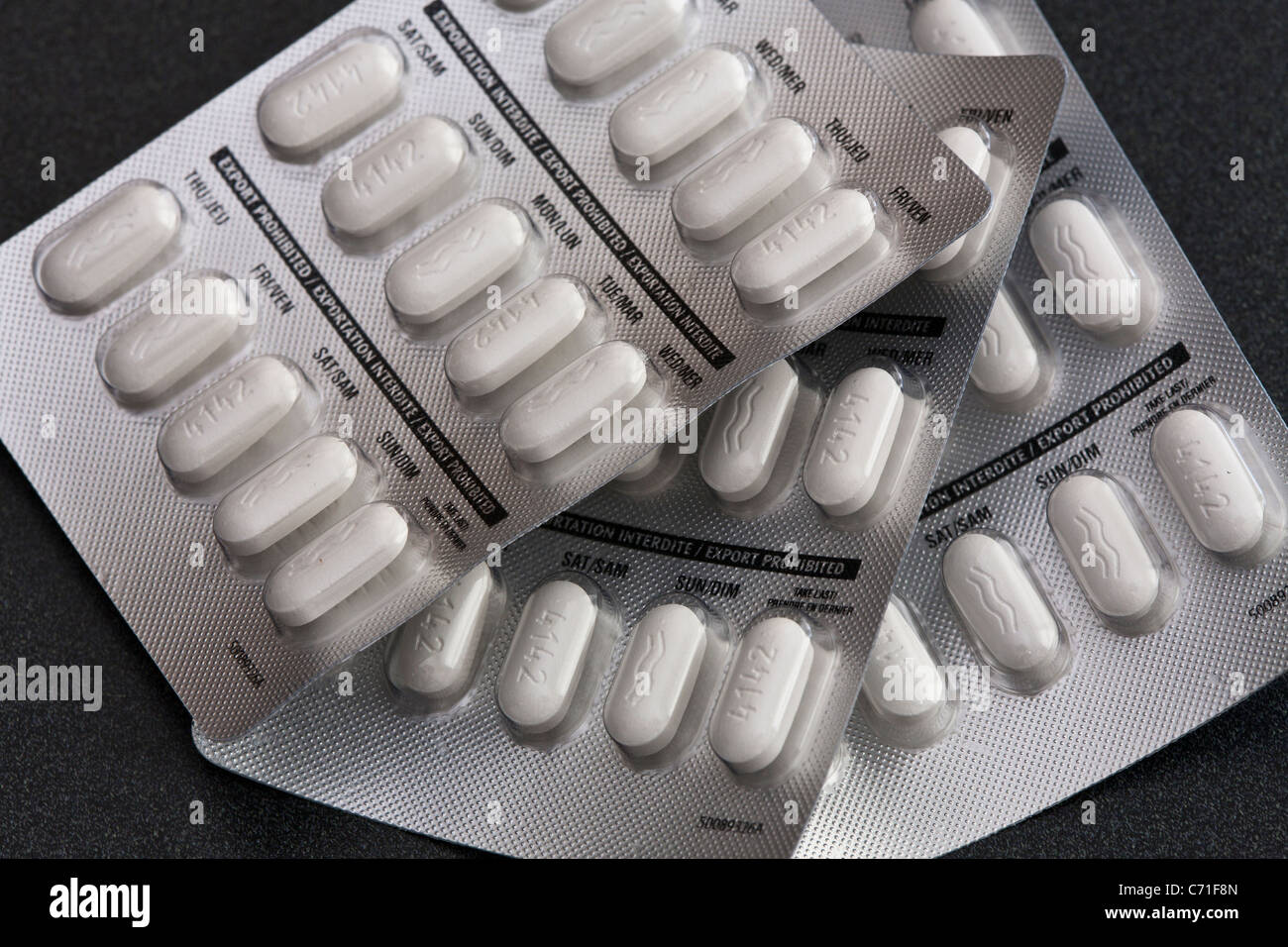 Blister packs of Multaq tablets. Three blister packs of pills against a ...