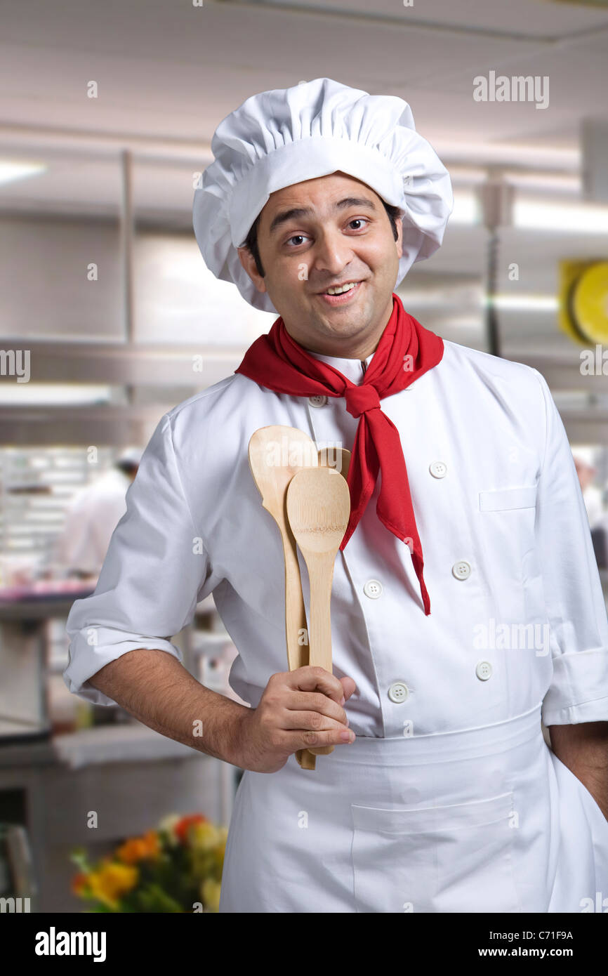 Portrait of a chef with wooden spoons Stock Photo - Alamy