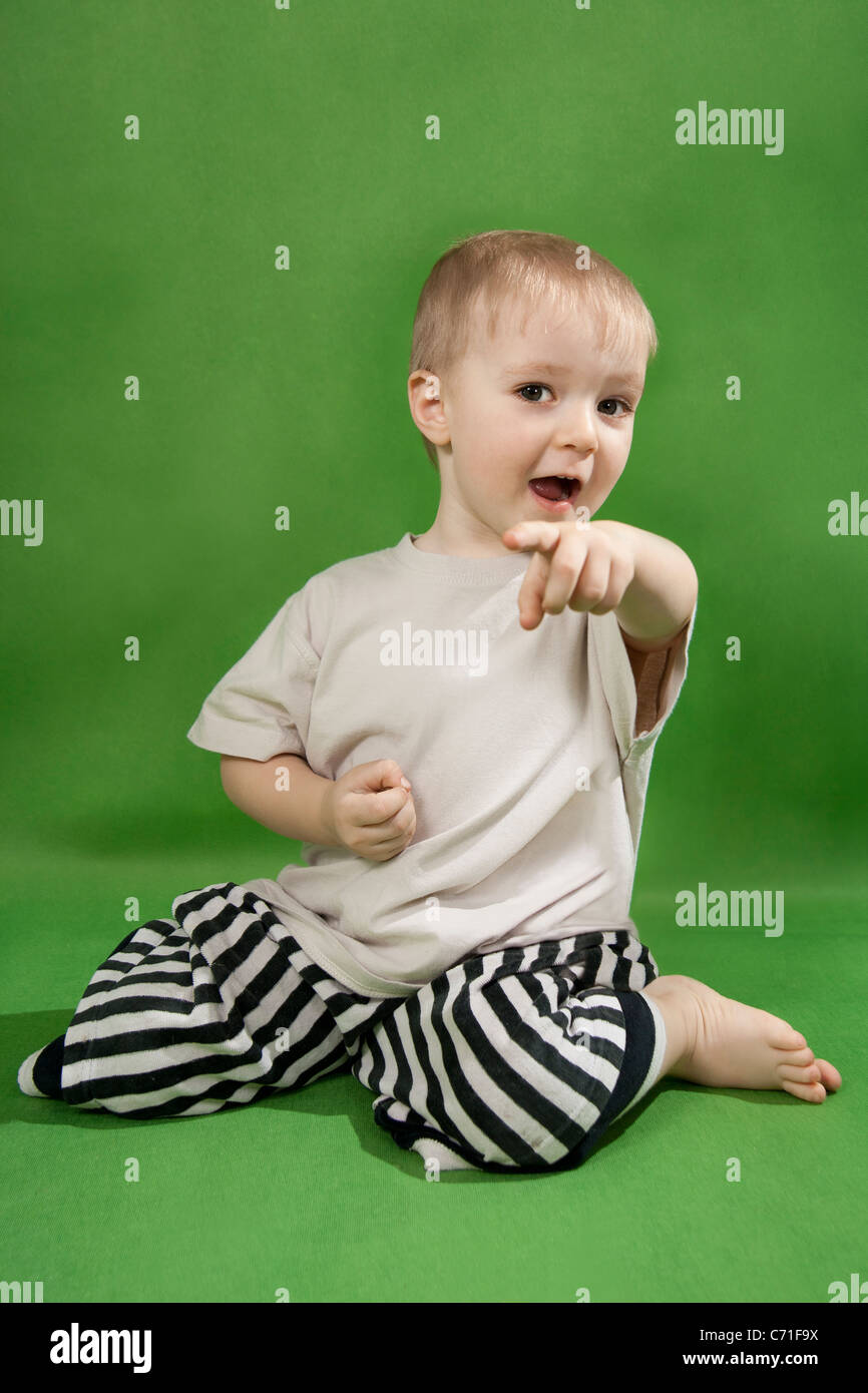 lovely little boy on a green background Stock Photo - Alamy