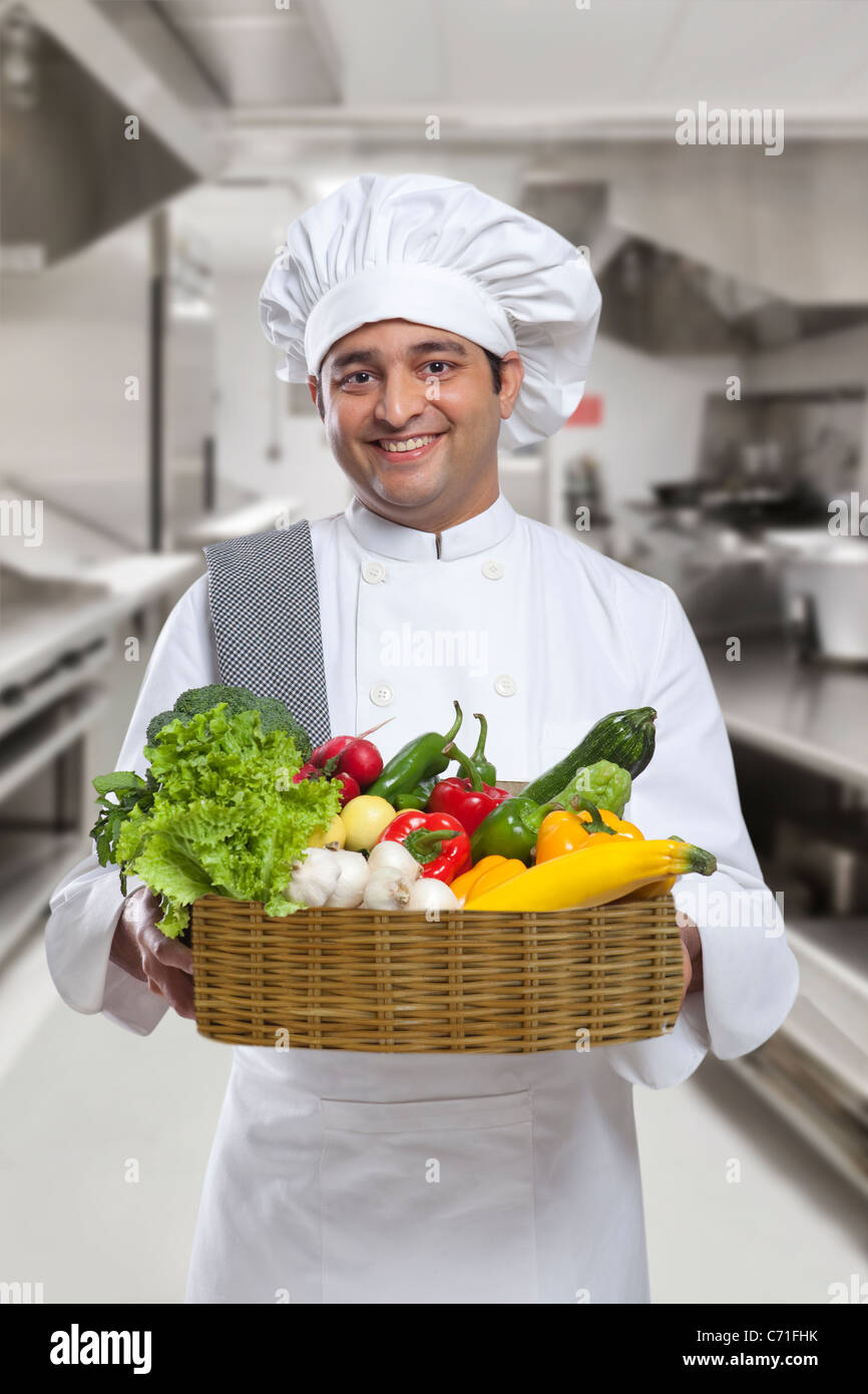 Chef carrying a basket of fresh vegetables Stock Photo - Alamy