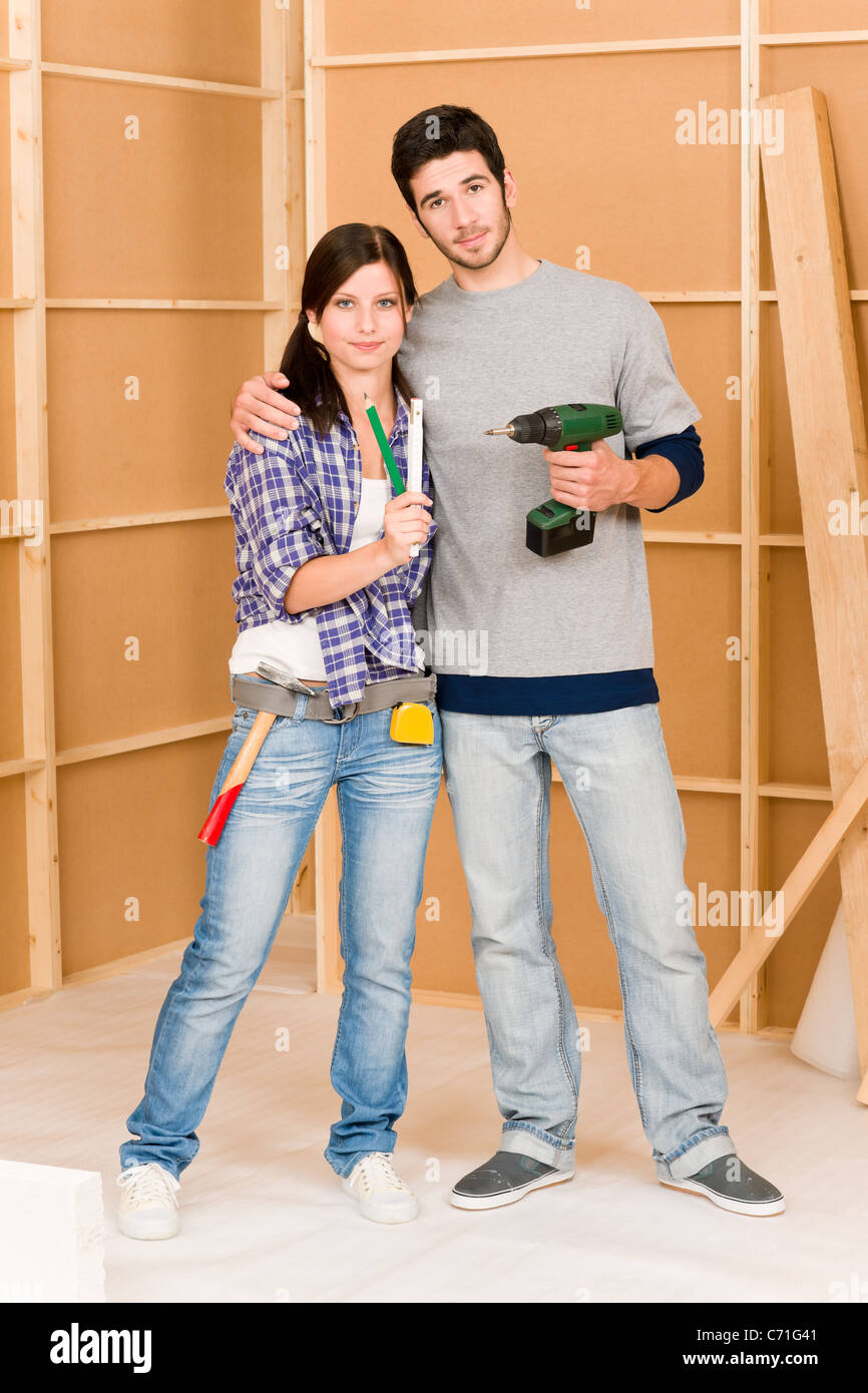 Home improvement young happy couple with repair tool hand drill ruler ...