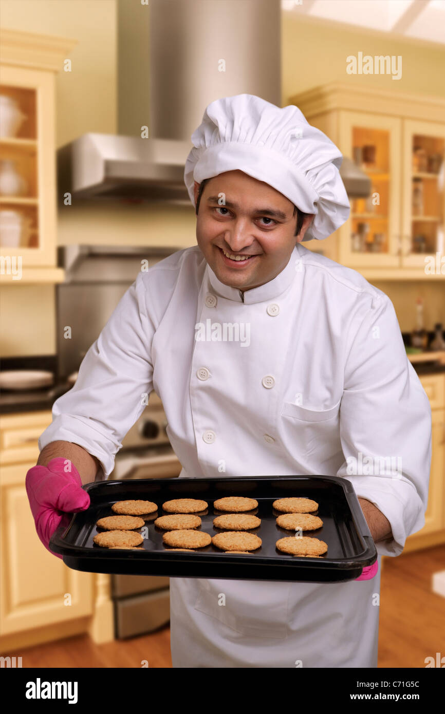 Chef offering baked cookies Stock Photo - Alamy