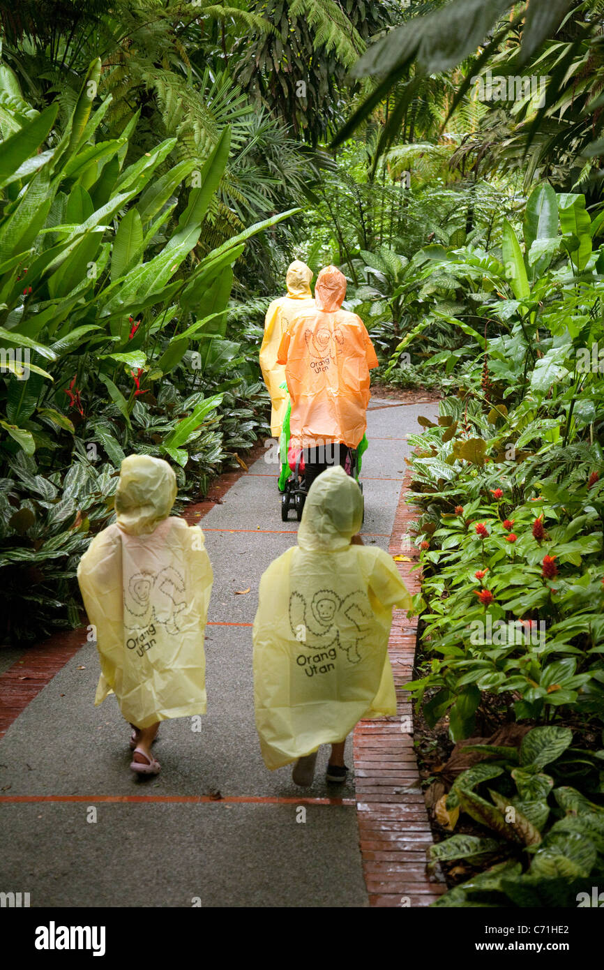 A family visits singapore zoo in the rain with their macs on, Singapore ...