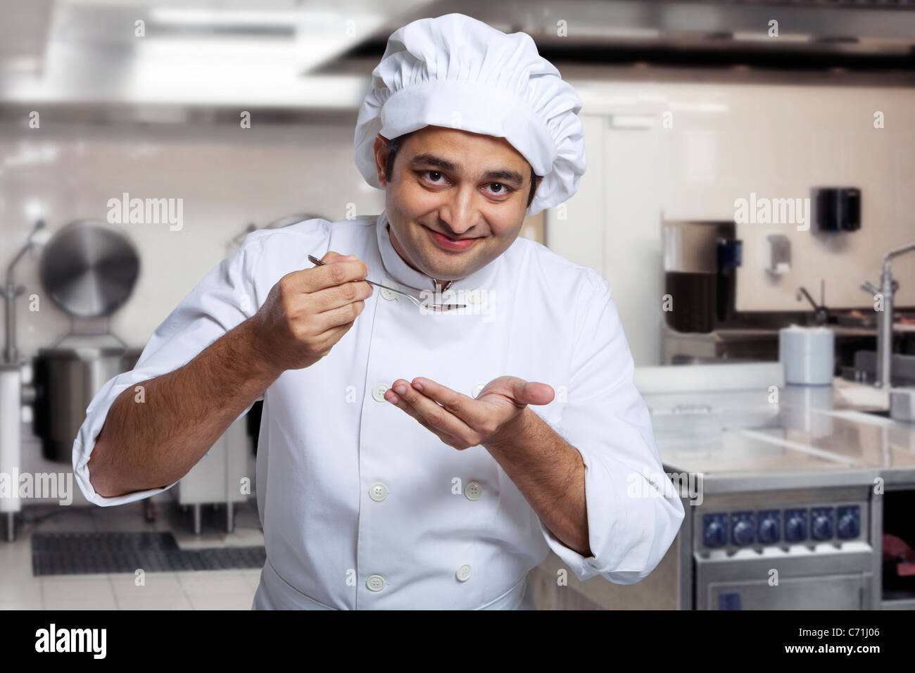 Chef tasting his cooking Stock Photo - Alamy