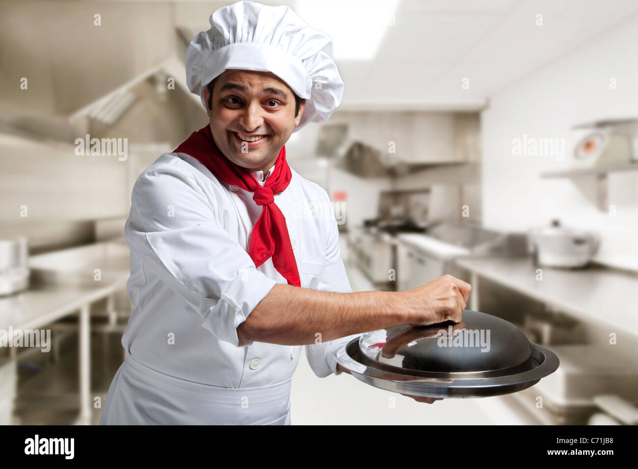 Portrait of a chef with a tray Stock Photo - Alamy