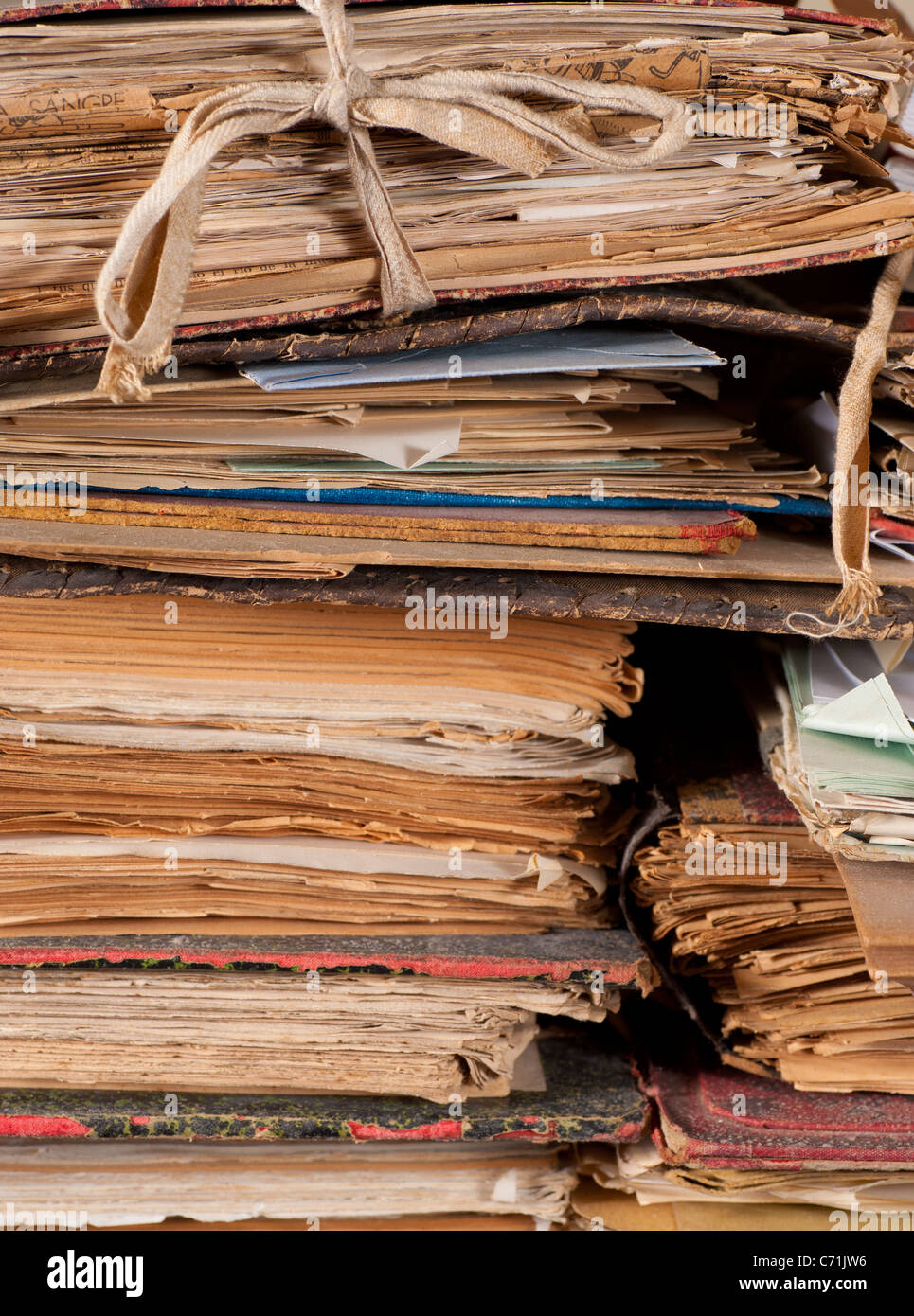 A stack of old files yellowing in an archive Stock Photo - Alamy