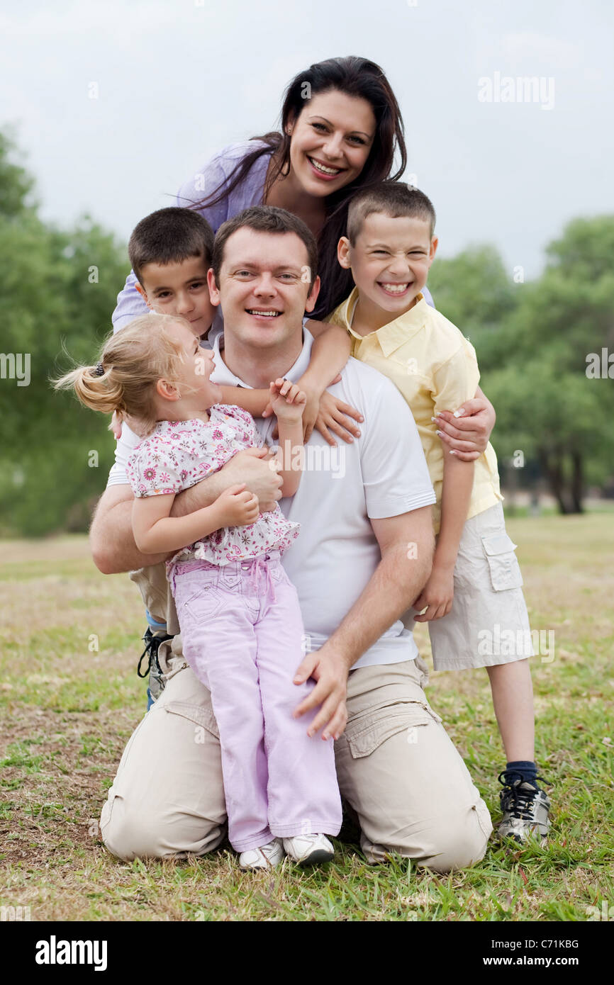 Close up shot of cheerful family posing together on natural background ...