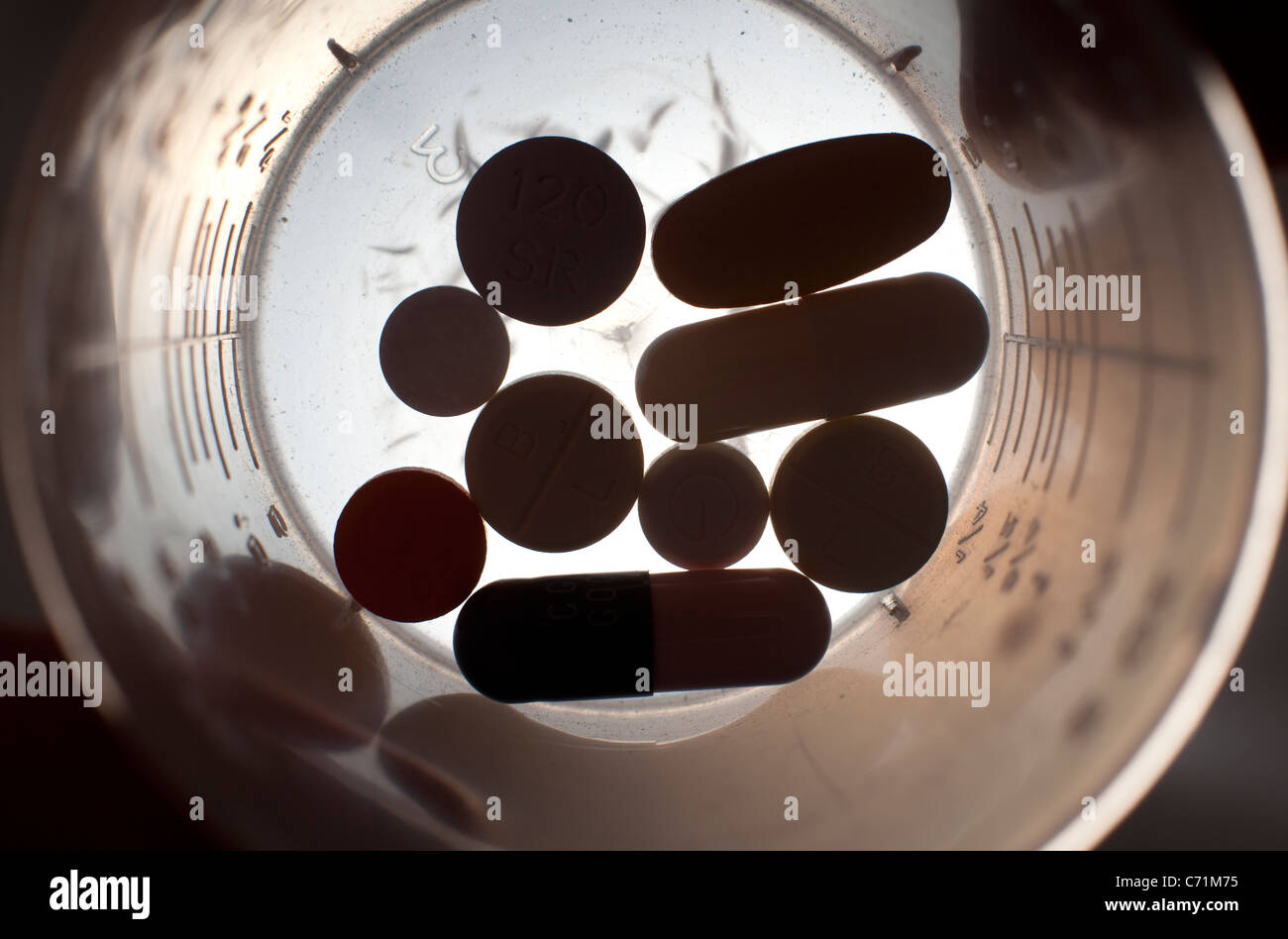 A dose of medication tablets in a plastic beaker Stock Photo - Alamy