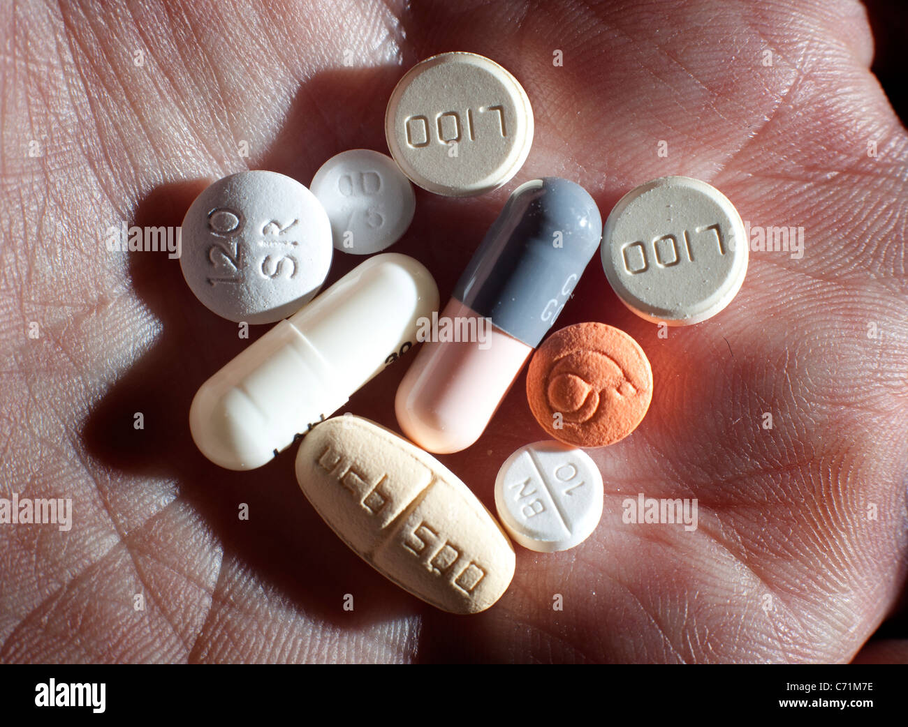 A dose of medication tablets in a plastic beaker Stock Photo - Alamy
