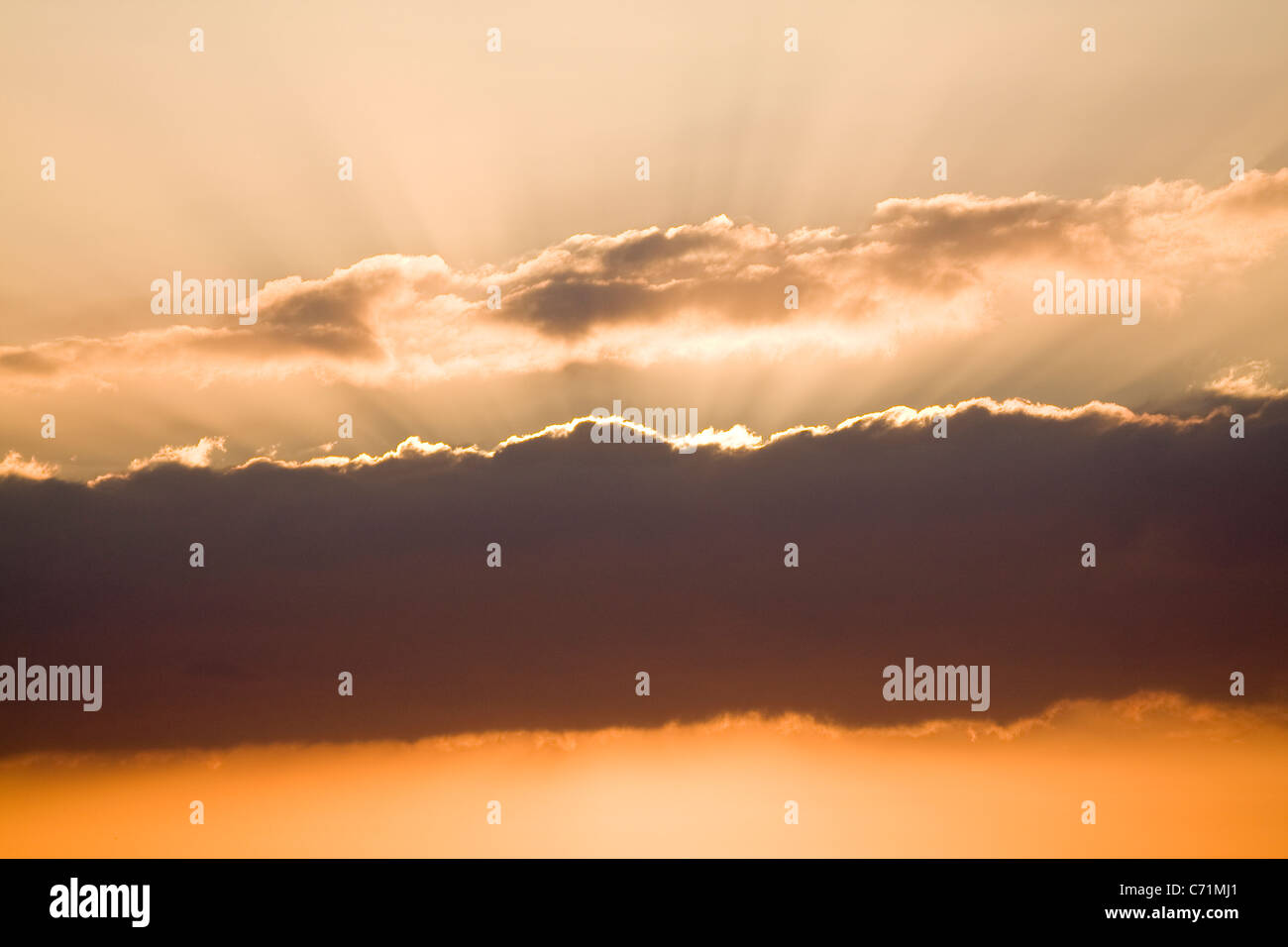 Sun Setting Behind Large Cloud Creating Rays of Light and Silver Lining ...