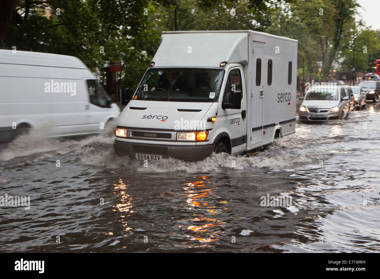 Heavy rain causes flash flooding in Stoke Newington, London. Traffic ...