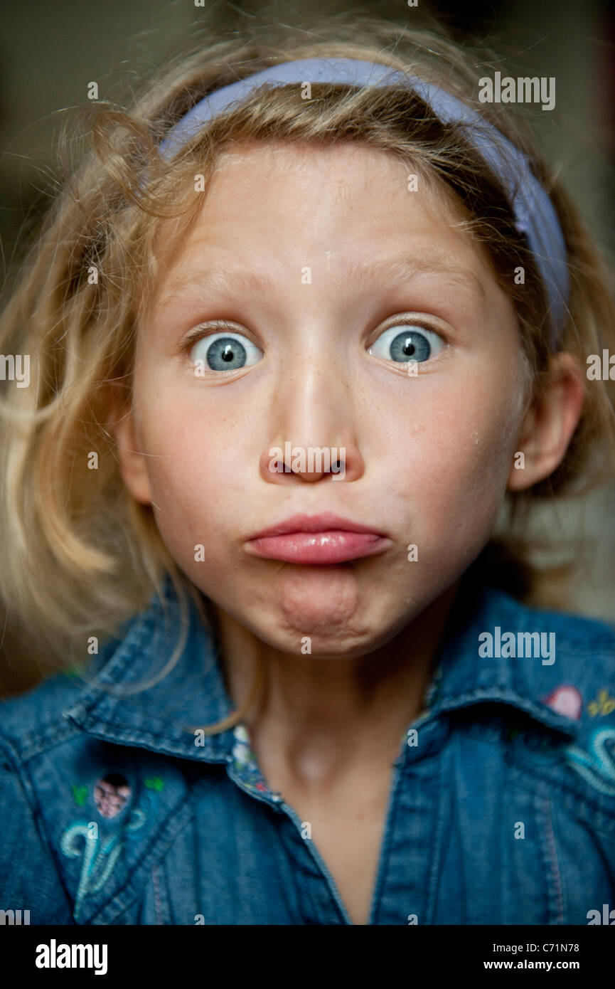 young girl makes silly faces for the camera Stock Photo - Alamy