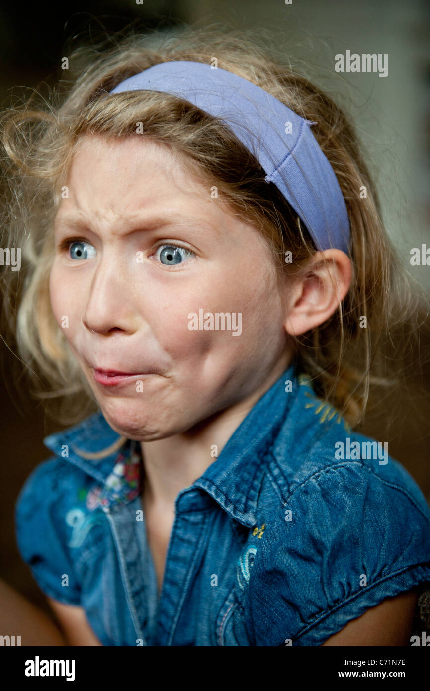 young girl makes silly faces for the camera Stock Photo - Alamy