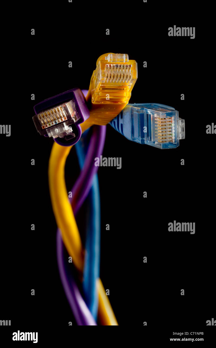 computer network cable twisted together against a black background ...