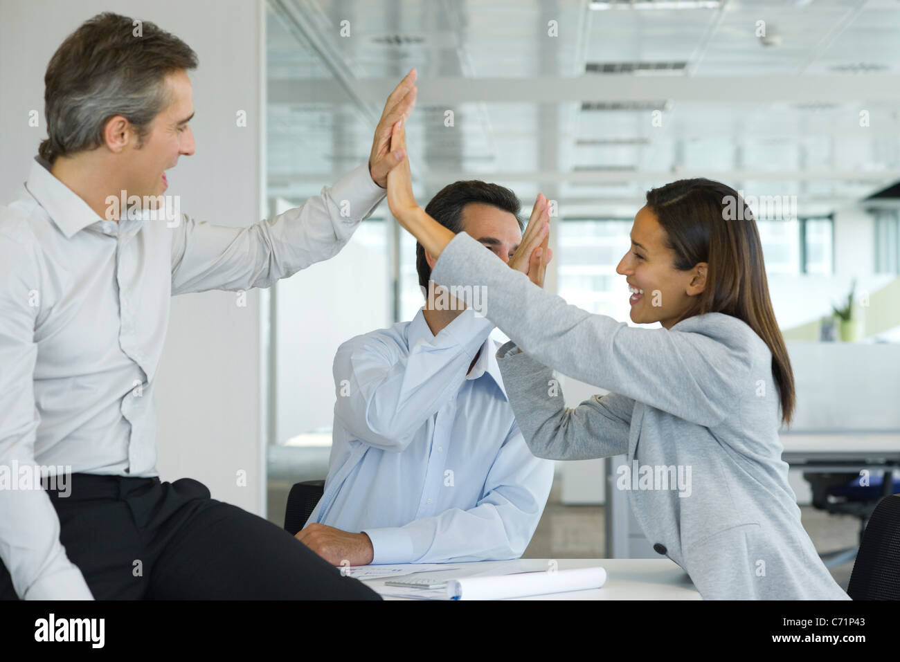 Colleagues giving high-five Stock Photo - Alamy