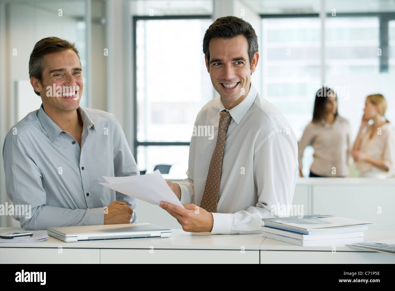Executives discussing documents Stock Photo - Alamy