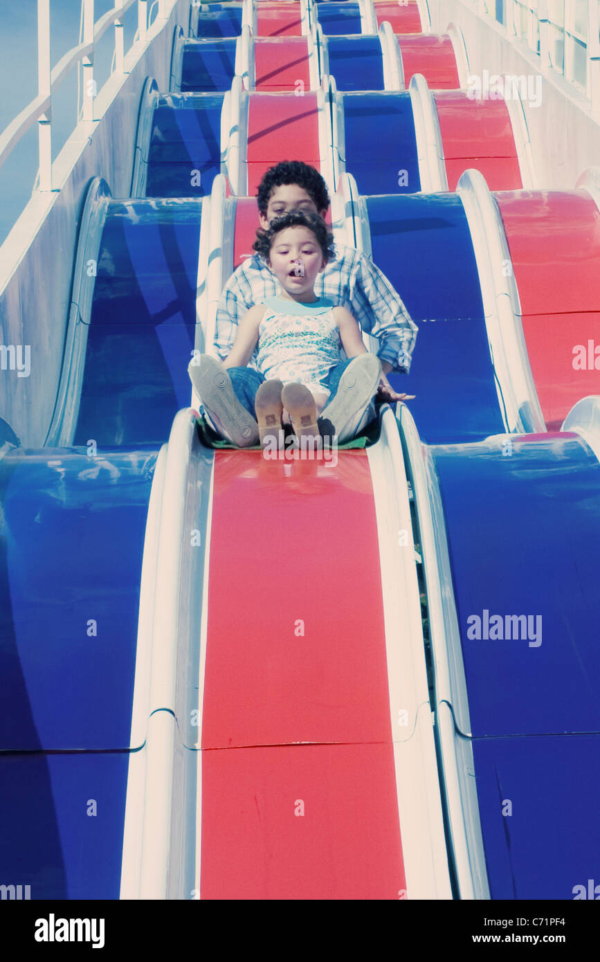 Children on slide, low angle view Stock Photo - Alamy