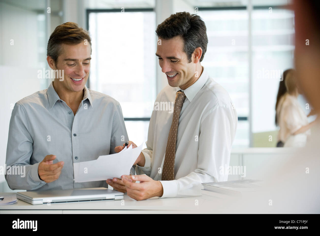 Executives discussing documents Stock Photo - Alamy