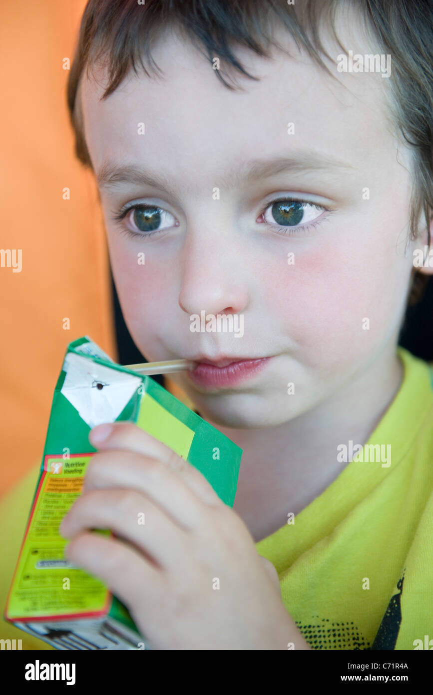 Little boy drinking juice box Stock Photo - Alamy