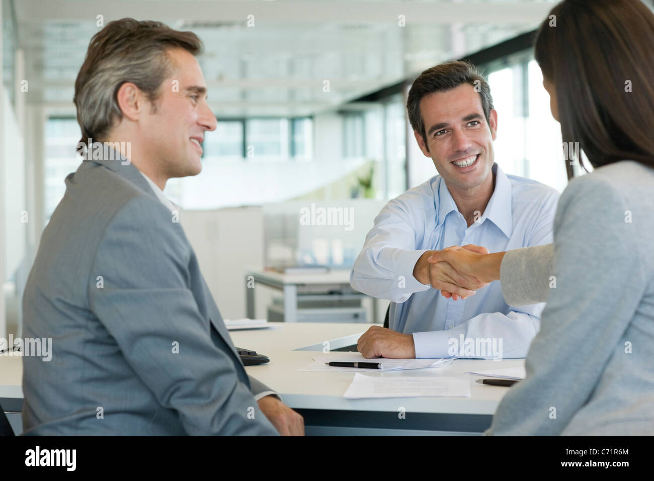 Businessman shaking hands with client Stock Photo - Alamy