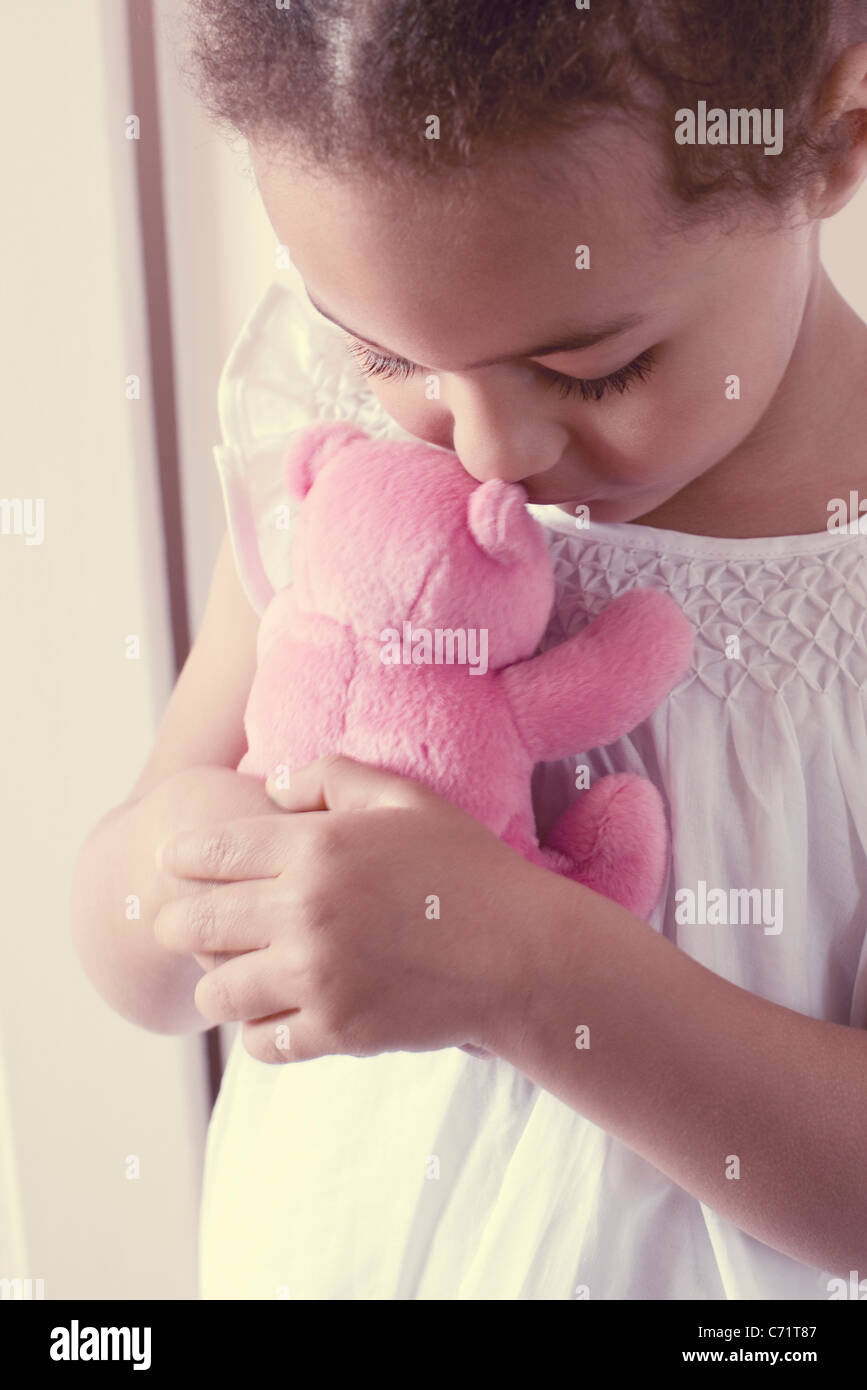 Little girl hugging teddy bear Stock Photo - Alamy