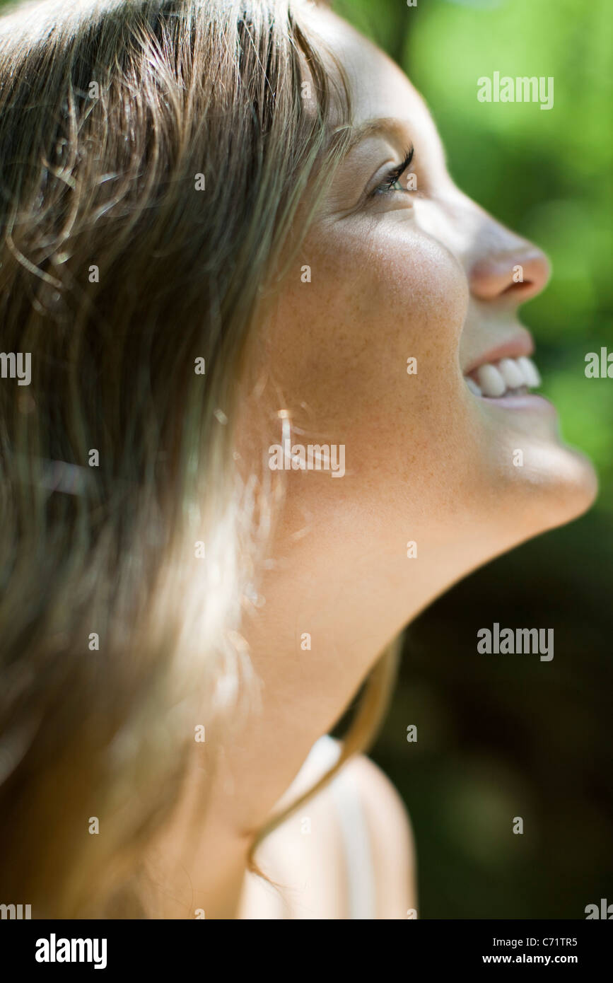 Happy young woman, side view Stock Photo - Alamy