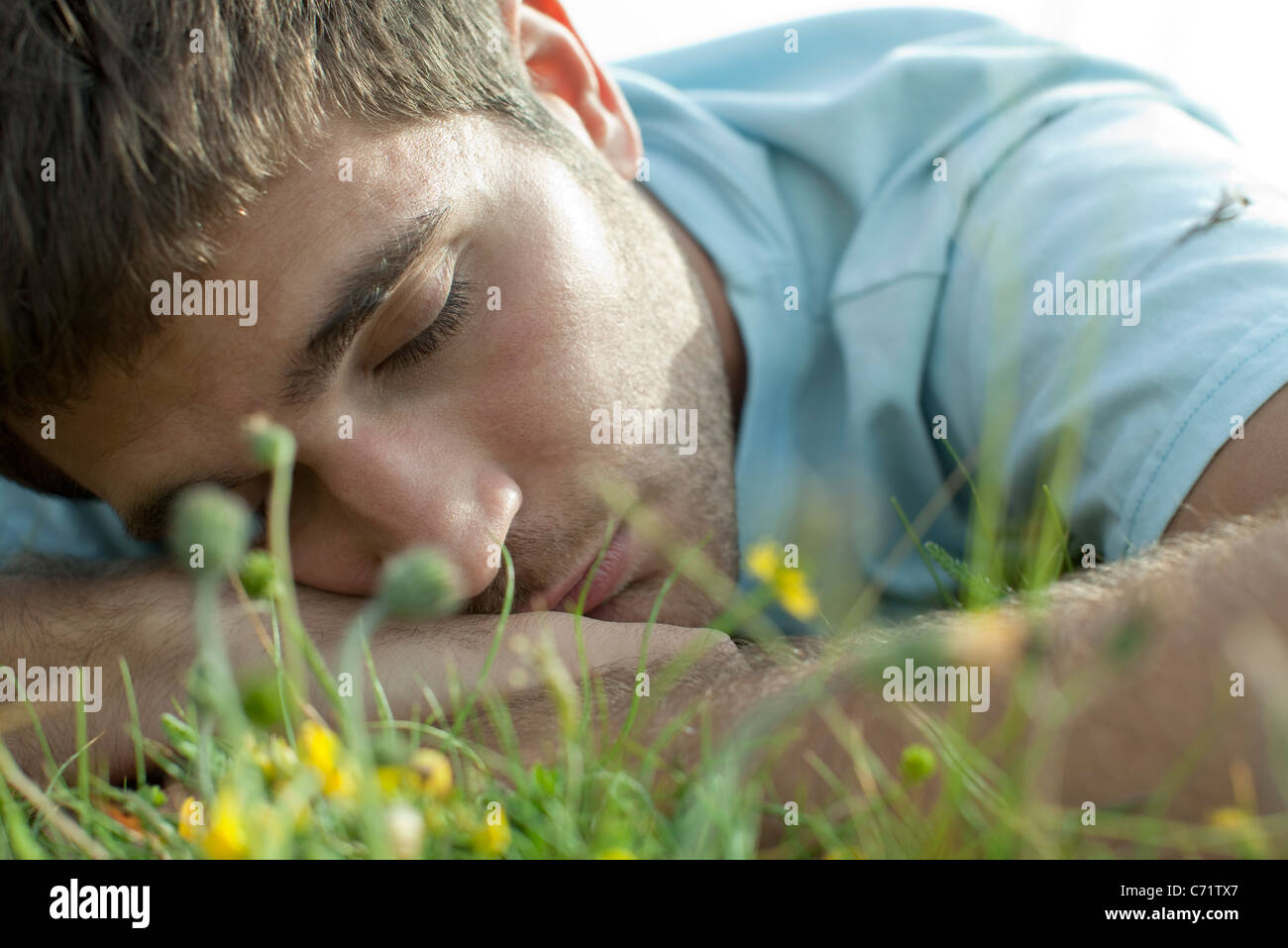 Man napping on meadow, close-up Stock Photo - Alamy