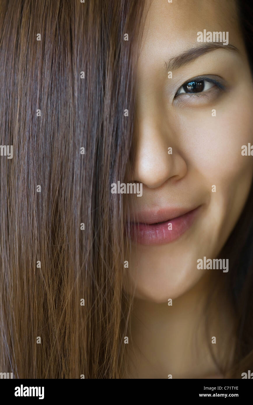 Young woman with hair covering half of face Stock Photo - Alamy