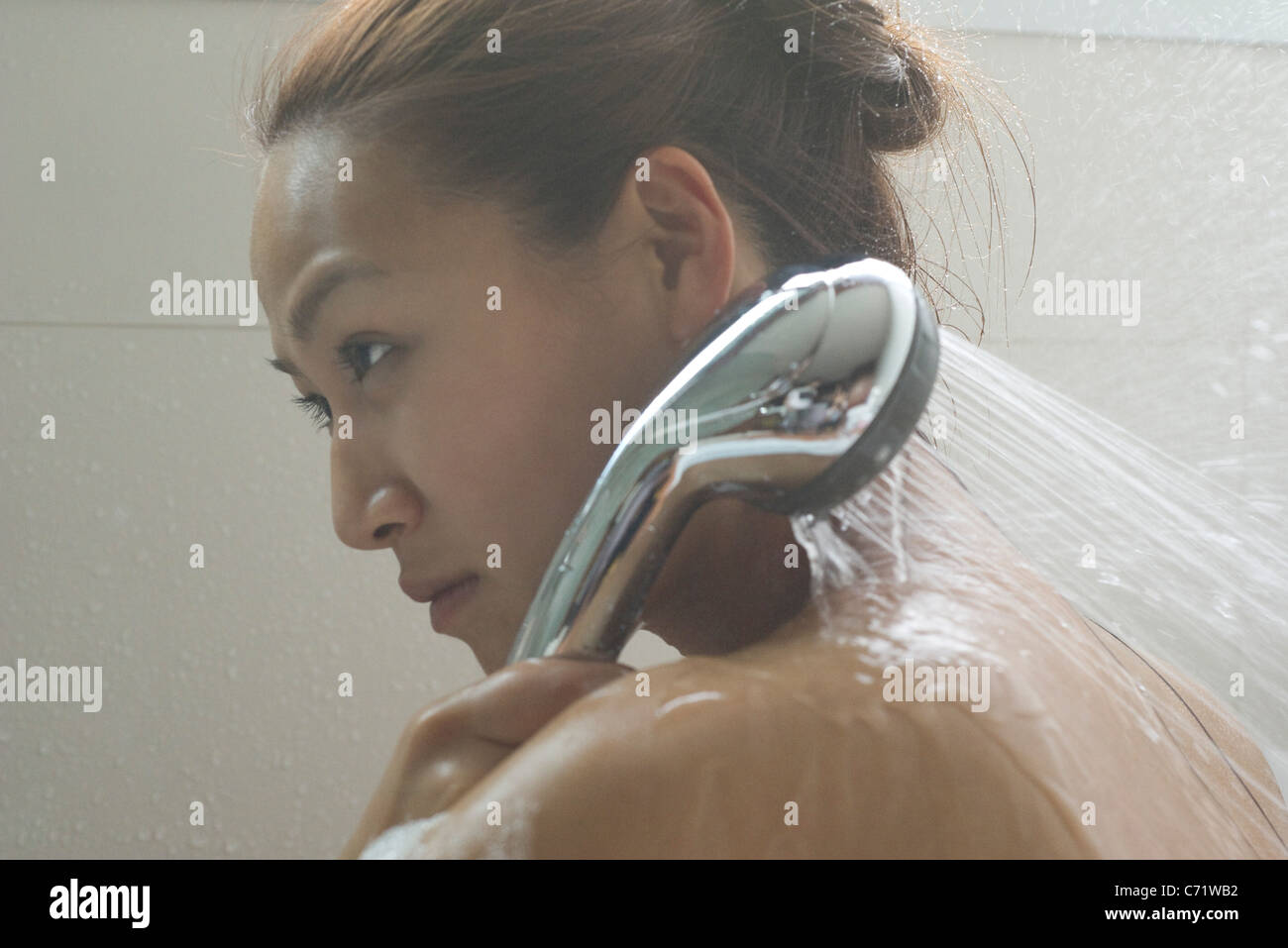 Young woman showering Stock Photo - Alamy