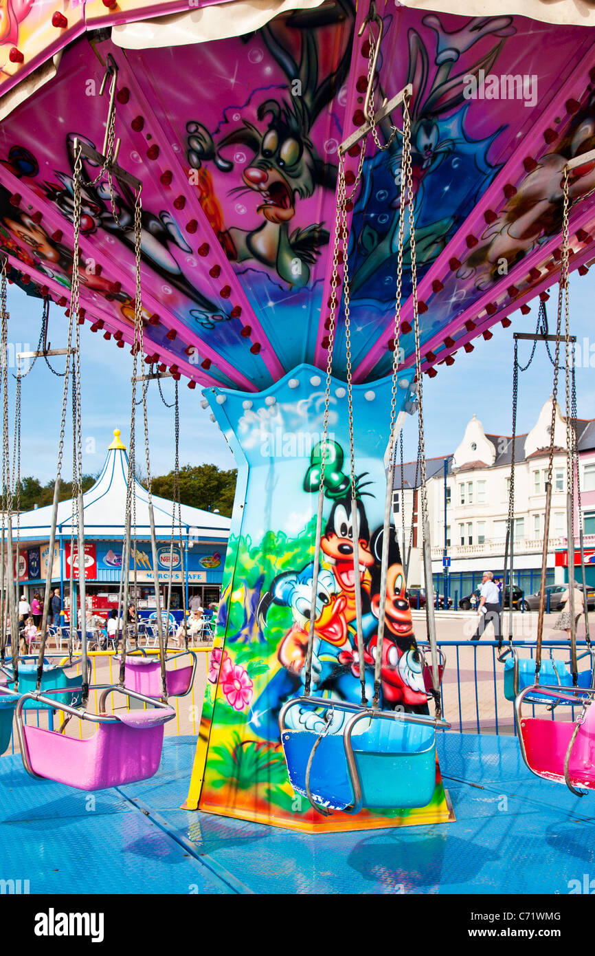 Brightly coloured chair-o-plane fairground ride, roundabout or swing ...