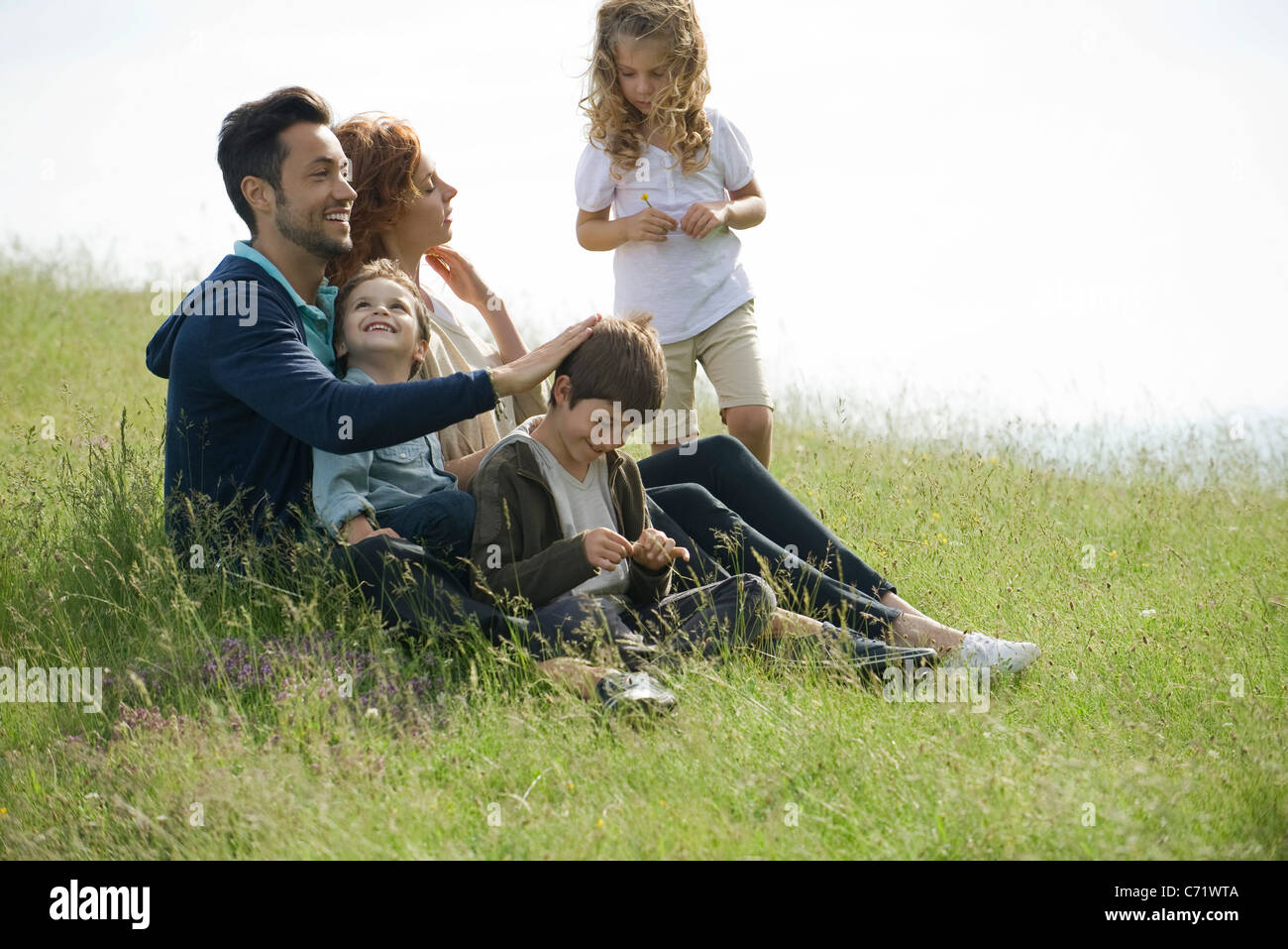 Family relaxing together outdoors Stock Photo - Alamy