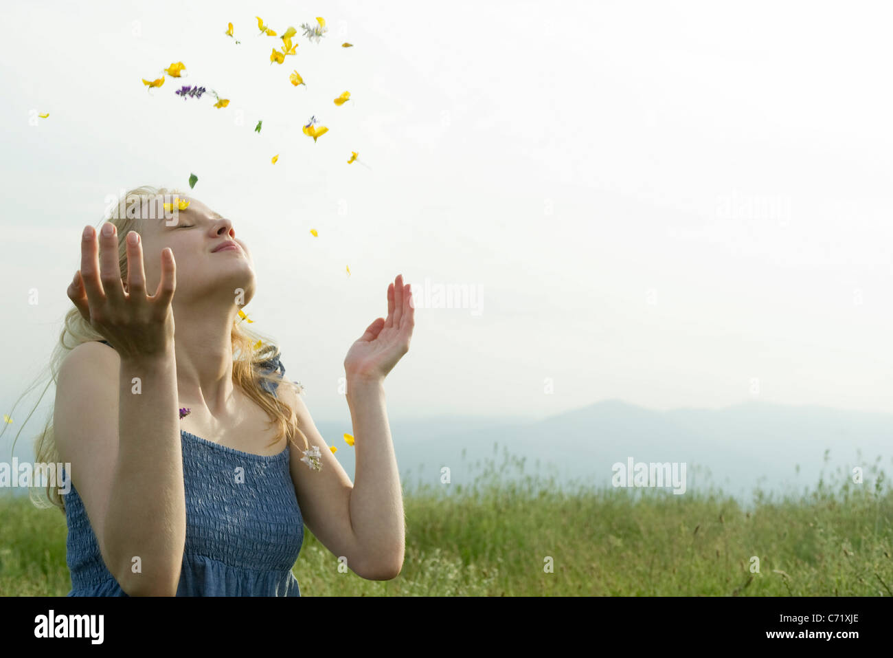Young woman throwing flowers on hi-res stock photography and images - Alamy