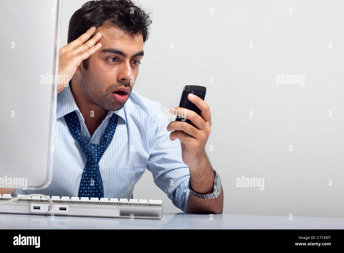 Businessman getting stressed while reading an sms Stock Photo - Alamy