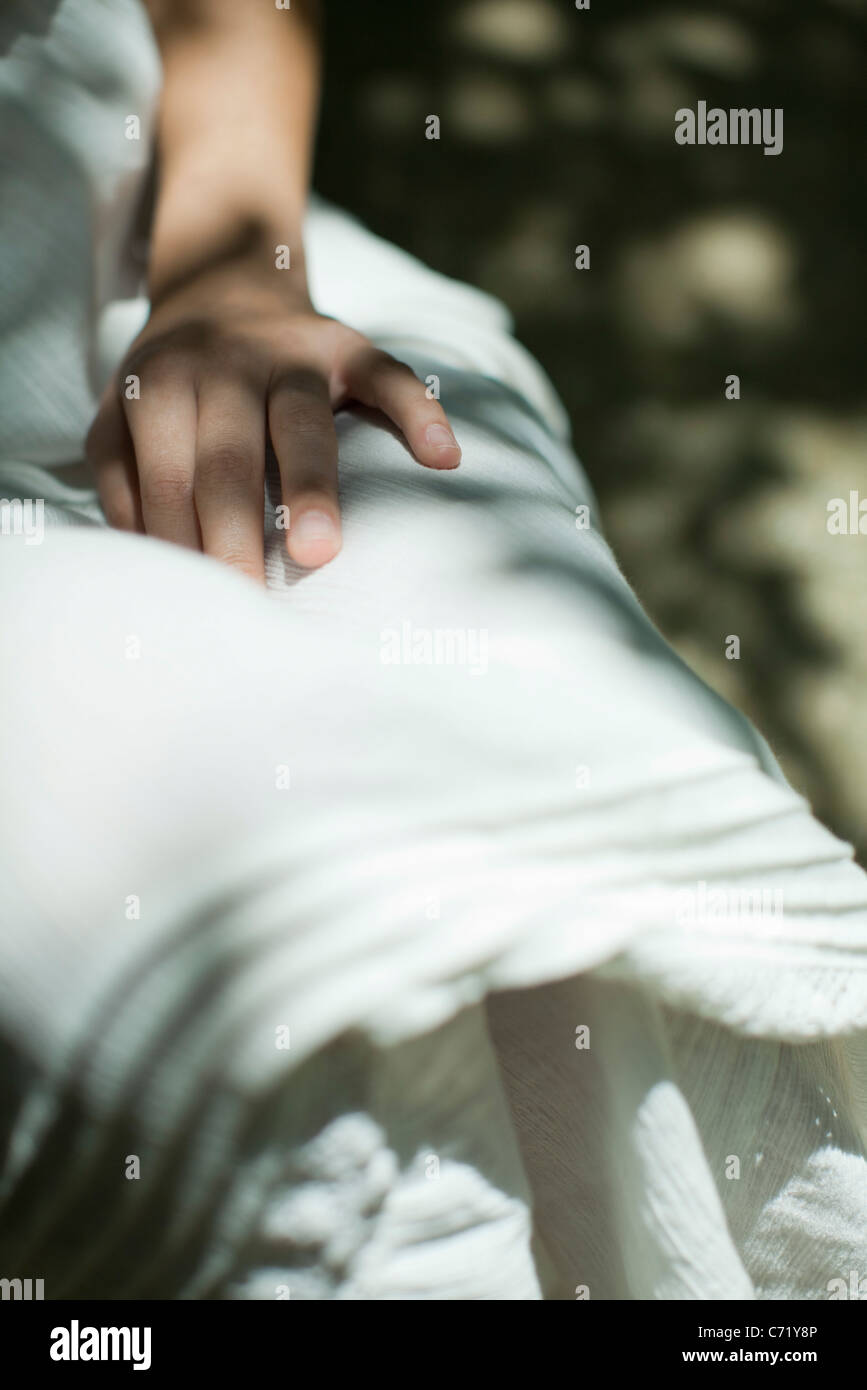 Woman sitting in shadow, mid section Stock Photo - Alamy
