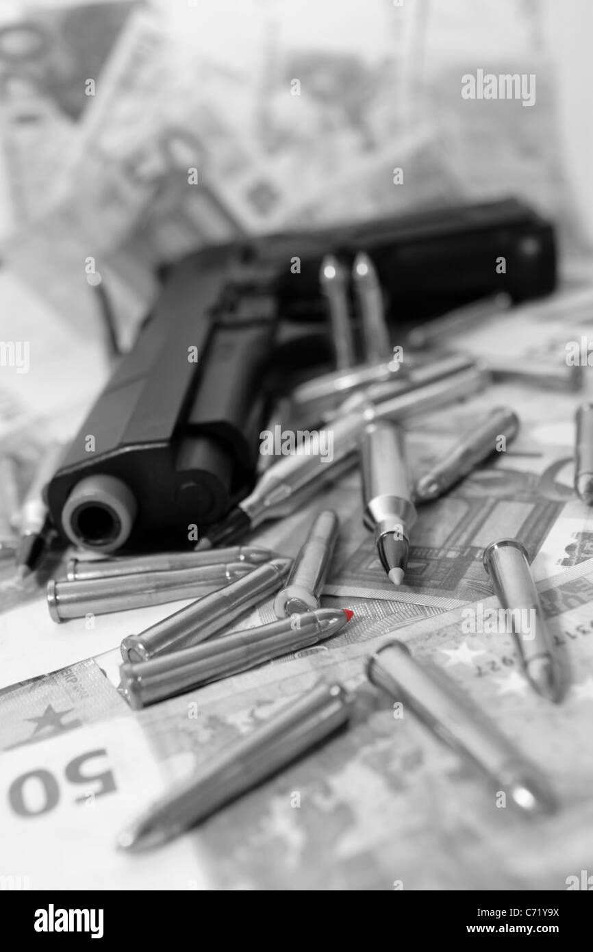 gun bullets and money showing a dangerous side to life Stock Photo - Alamy