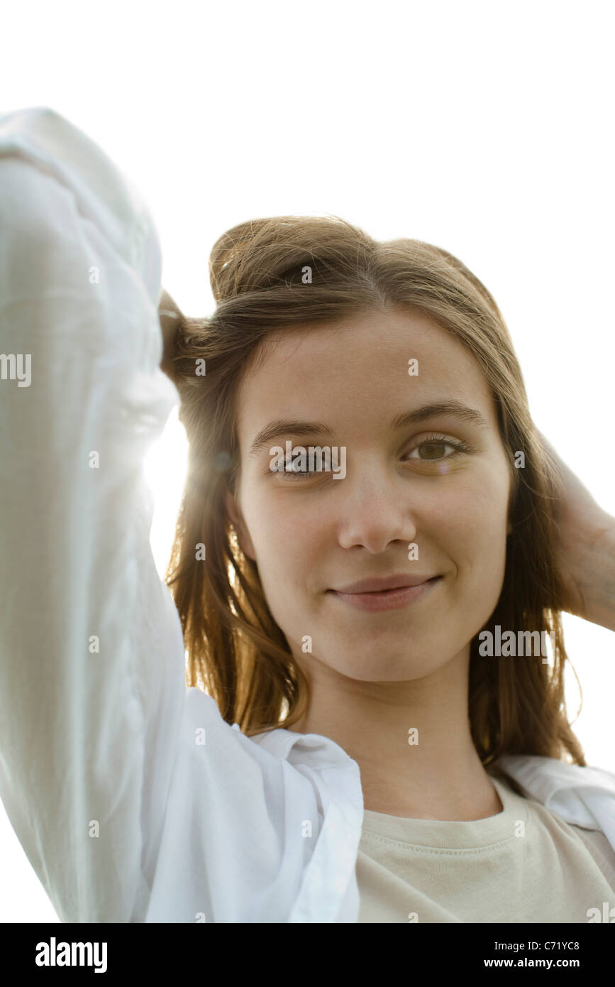 Young woman with hand in hair, portrait Stock Photo - Alamy