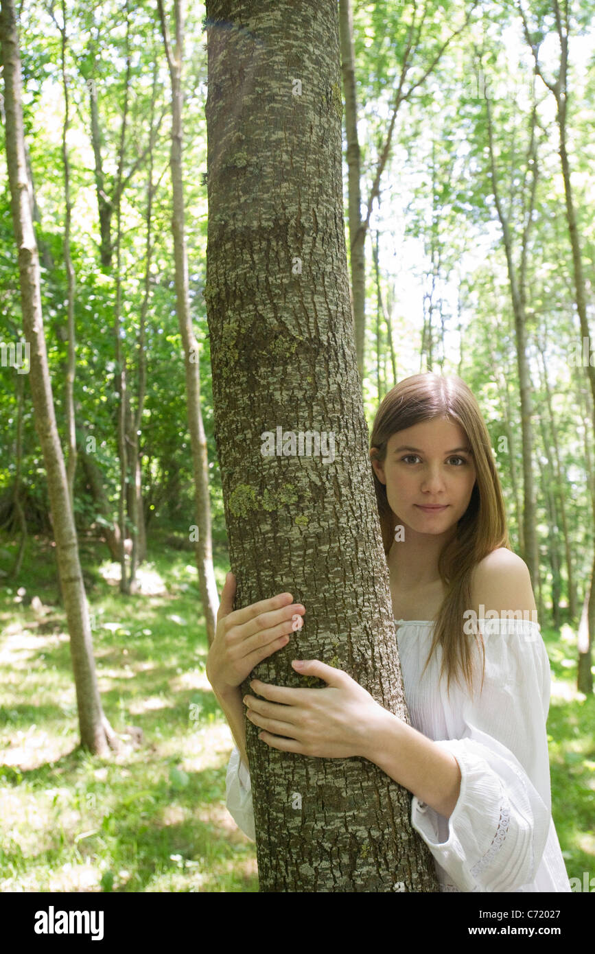 Young woman hugging tree, portrait Stock Photo - Alamy