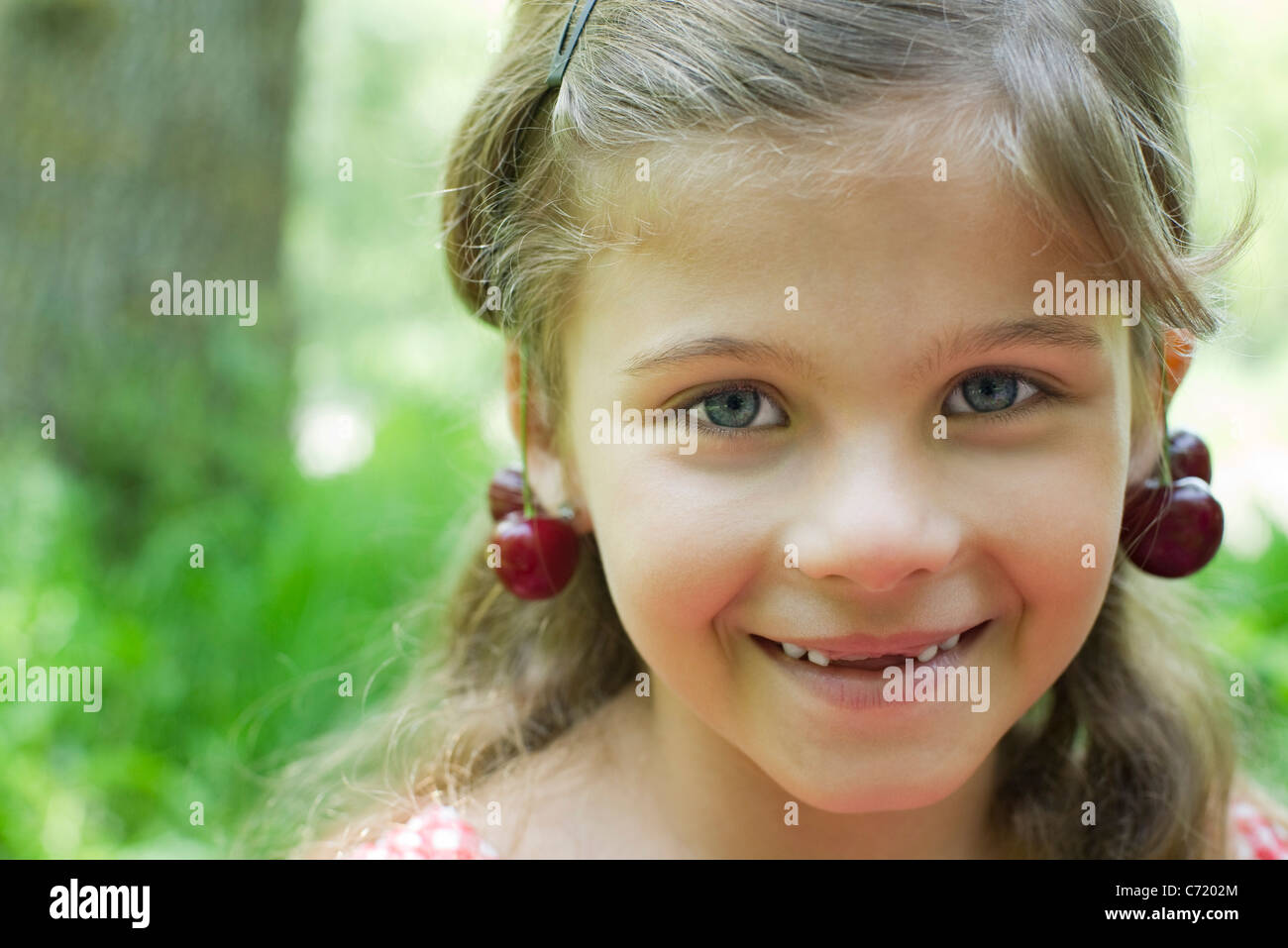 Girl cherries dangling from ears hi-res stock photography and images ...